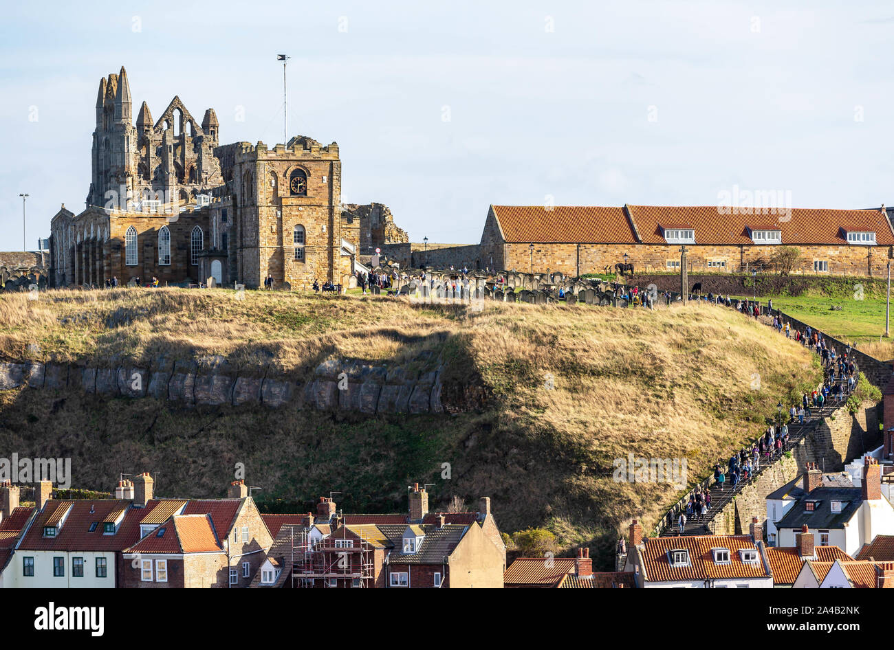 People crowding the 199 steps to Whitby Abbey and The Church of Saint ...