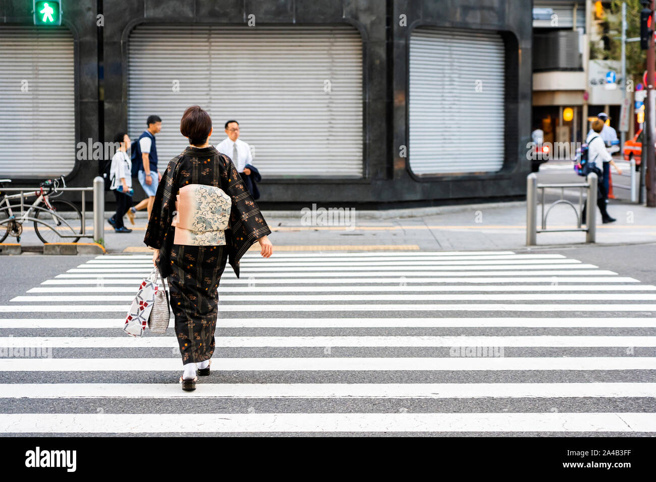 TOKYO, JAPAN - OCTOBER 6, 2018. Japanese Woman is Crossing Road Wearing ...