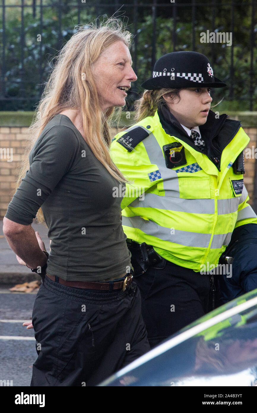 London, UK. 13 October, 2019. Police officers arrest a climate activist ...