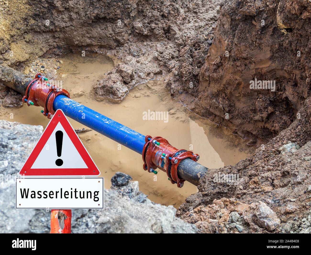 Water pipe burst Warning sign in German Stock Photo - Alamy