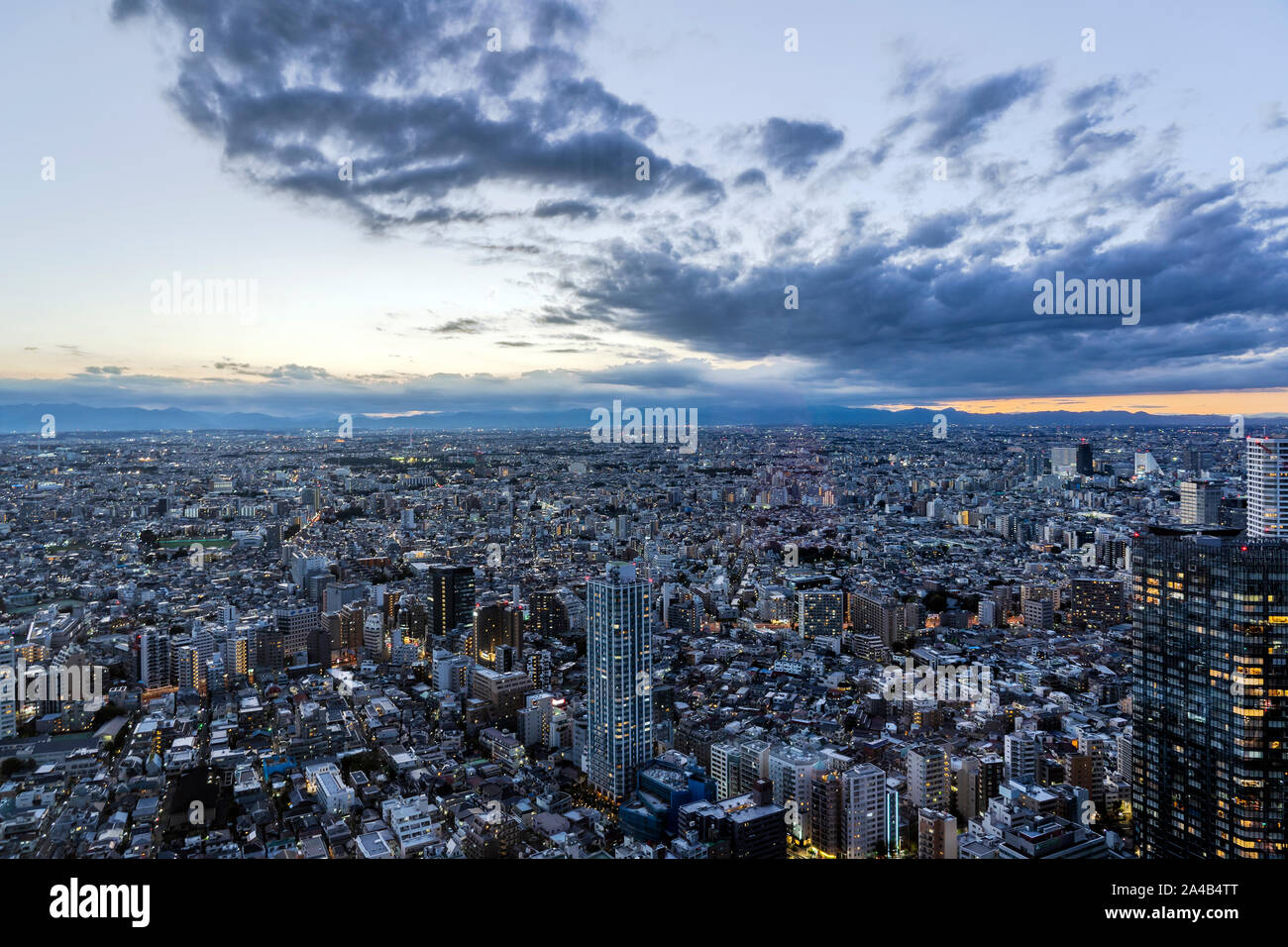 Sunset of Tokyo Skyline and the Illuminated City. Lights in Windows and ...