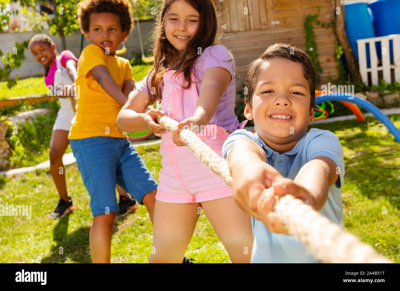 Strong kids pull rope in the competitive game Stock Photo - Alamy