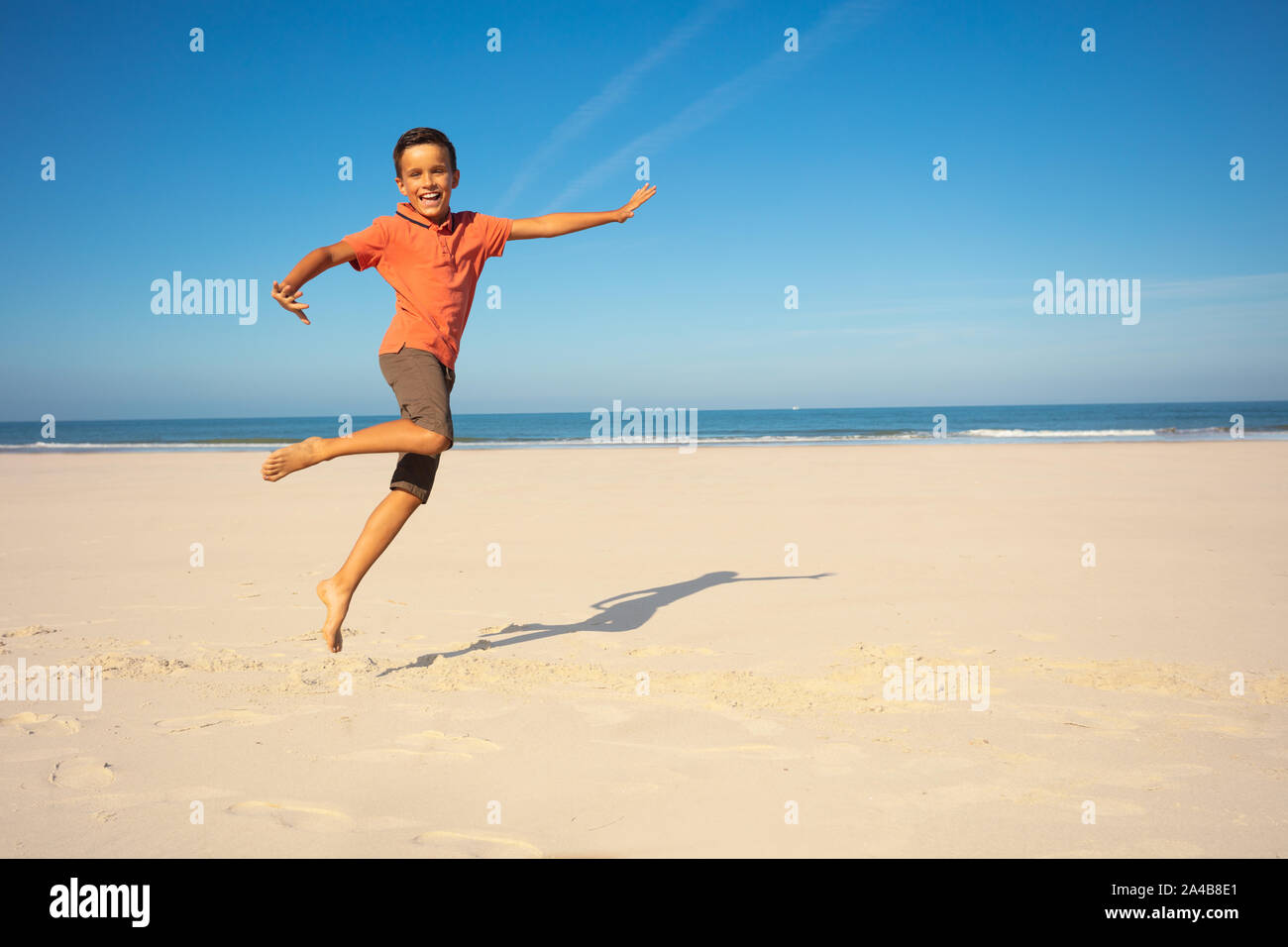 Boy jump and dance on the sand sea beach Stock Photo - Alamy