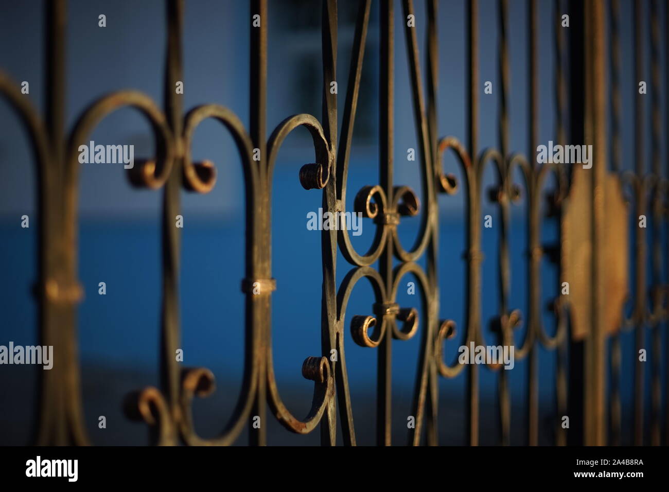 black forged fence with curls, perspective view Stock Photo - Alamy