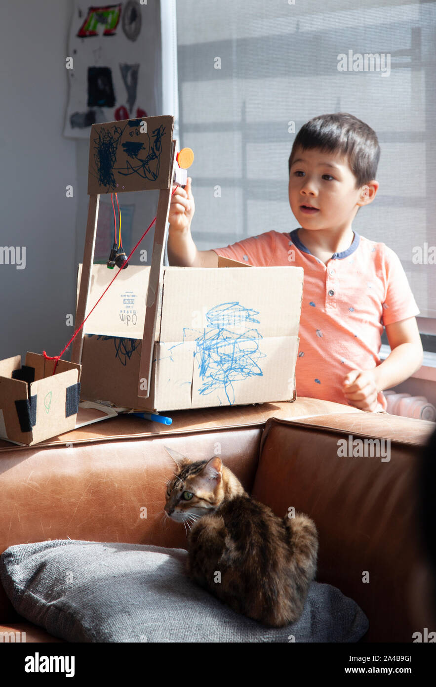 boy playing with homemade robot Stock Photo - Alamy