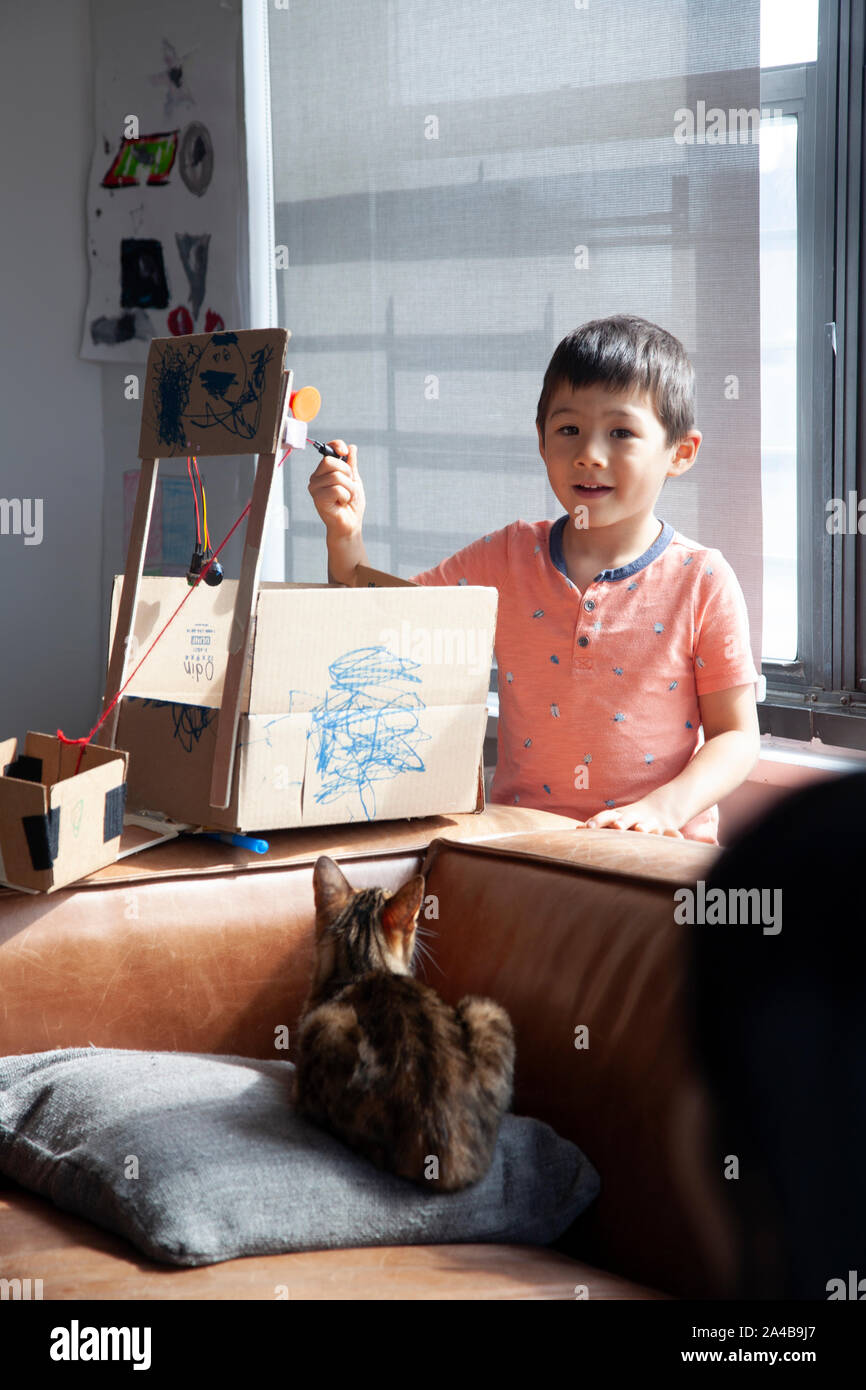 boy playing with homemade robot Stock Photo - Alamy