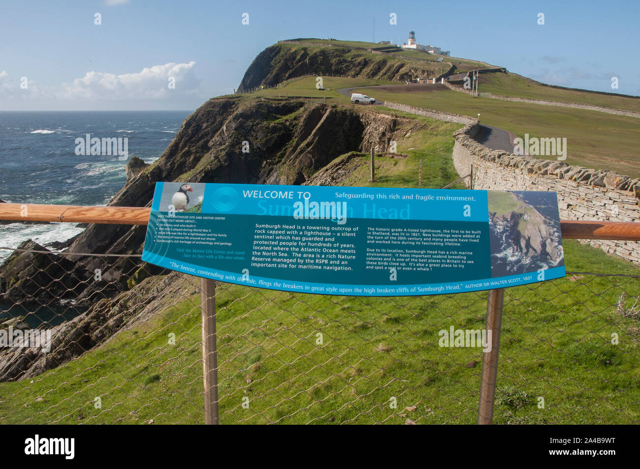 Information board at Sumburgth Head RSPB Reserve with lighthouse in the ...