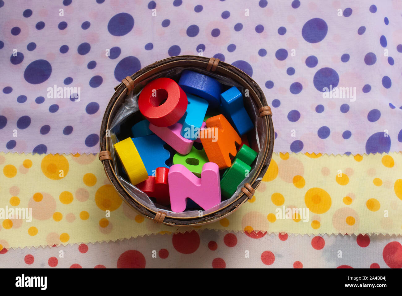 Colorful wooden letters in a container on a colorful background Stock ...