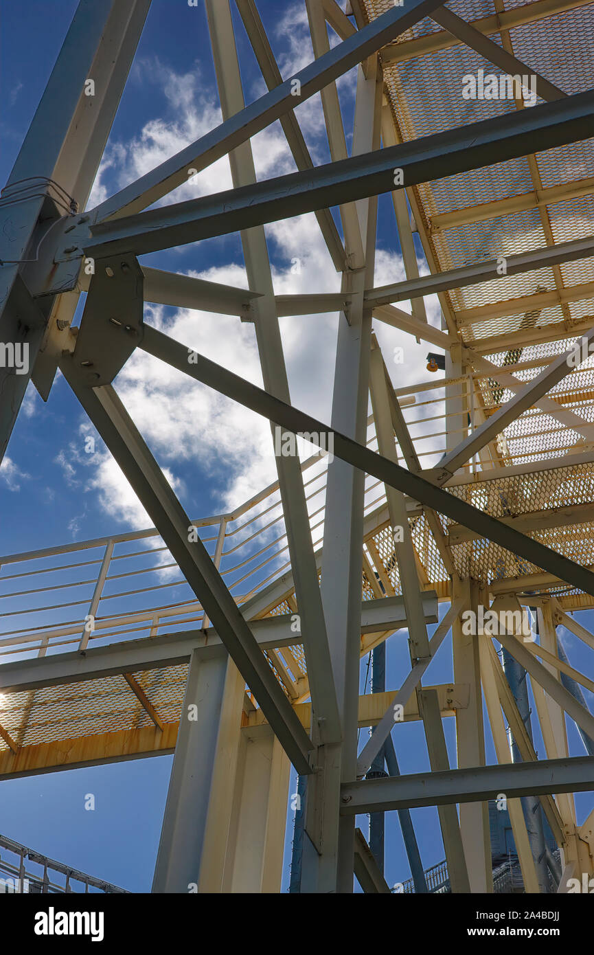 Industrial construction. Metal structures against the blue sky and ...