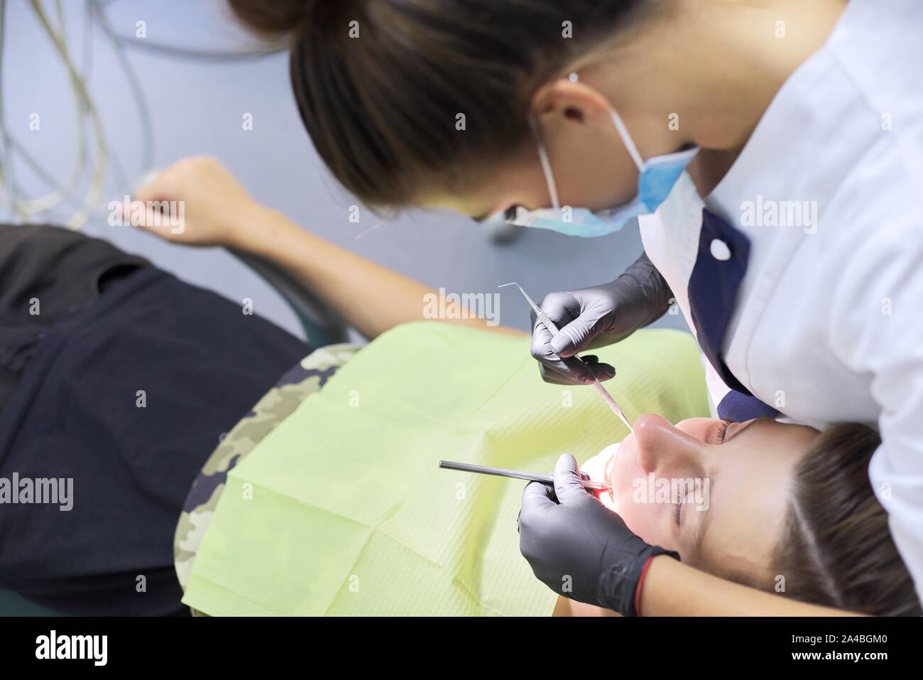 Dental treatment at the dental clinic, female doctor treating patient ...