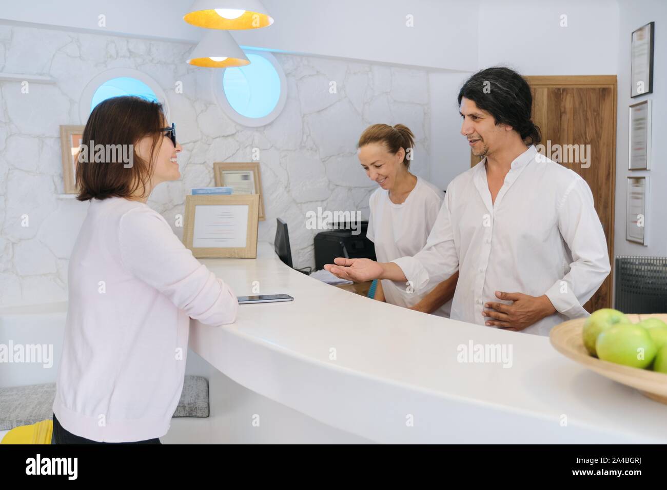 Reception at the resort hotel. Man and woman receptionists at the ...