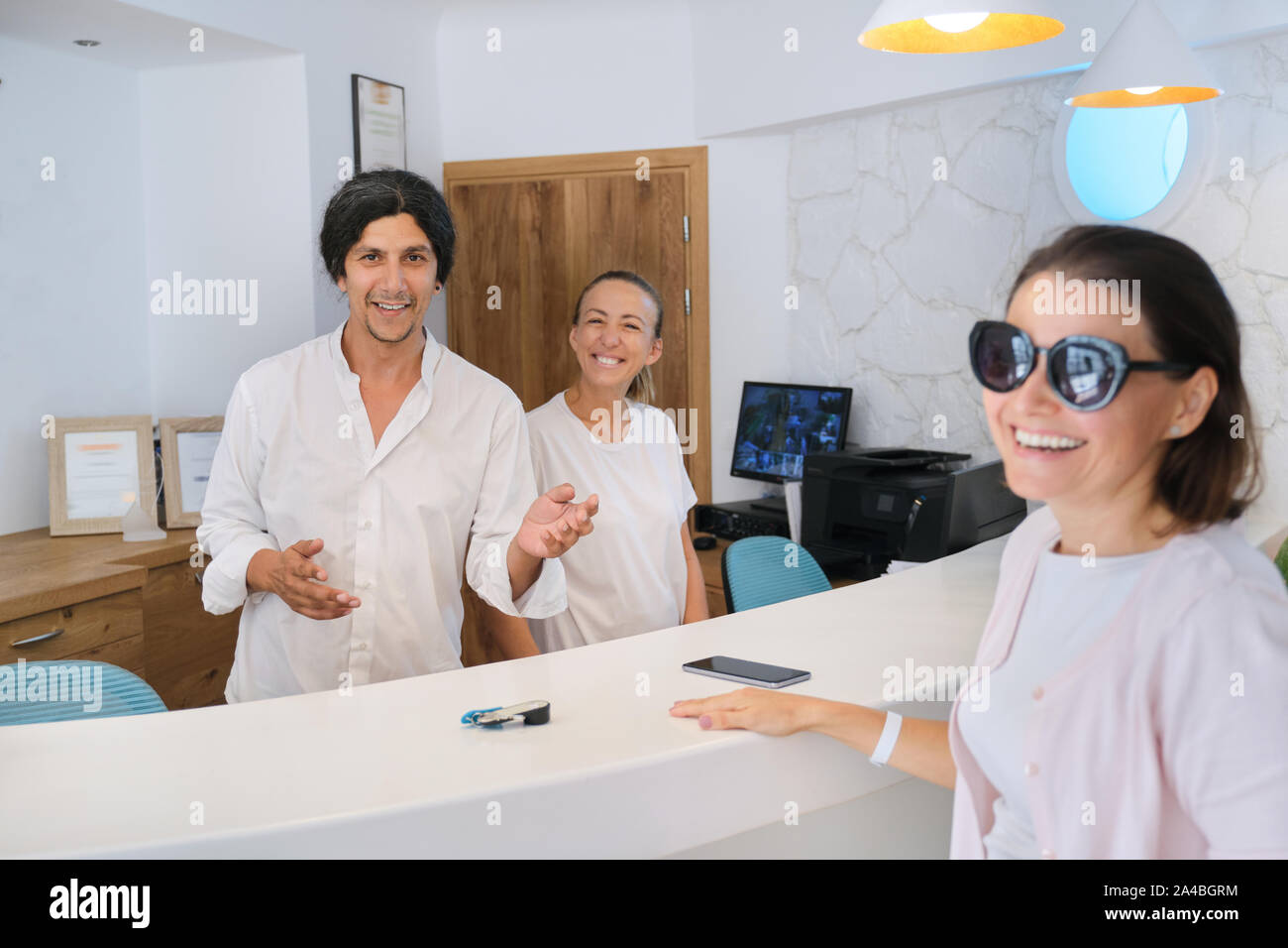 Resort hotel reception and registration of guests. Man and woman ...