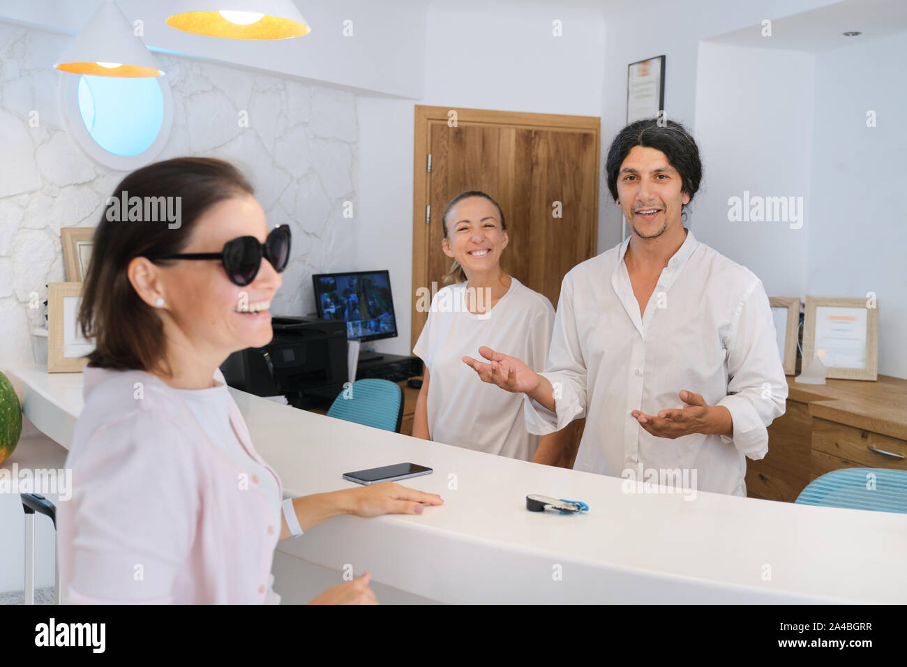 Resort hotel reception and registration of guests. Man and woman ...