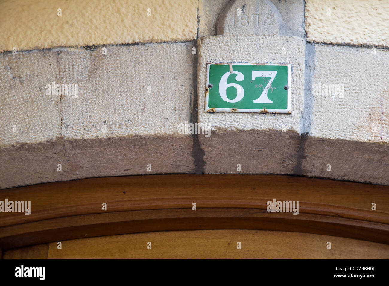 Mediterranean style white numbers 67 on a green enamel plaque over a ...