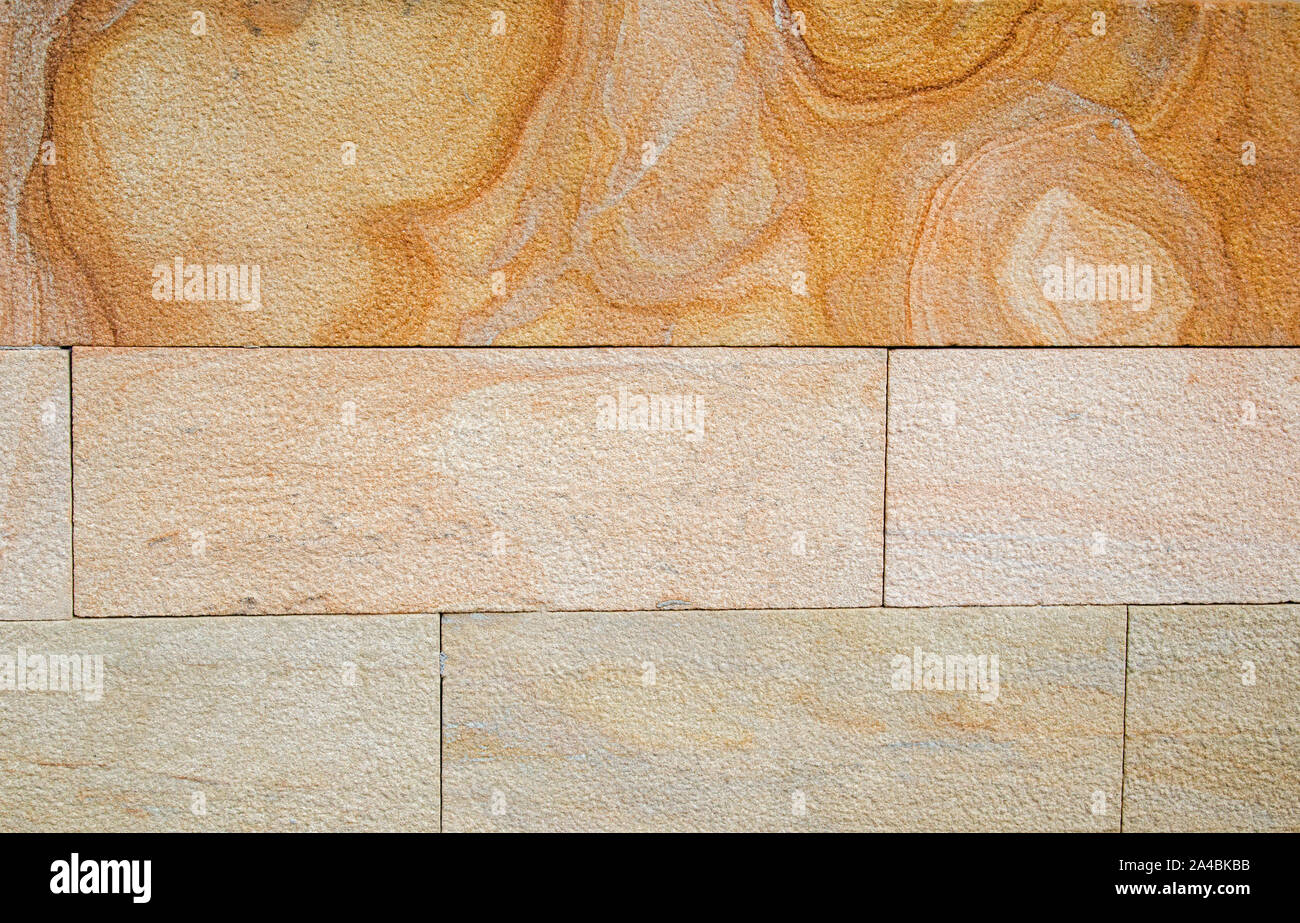 Golden coloured sandstone blocks in a wall, shot landscape format for ...