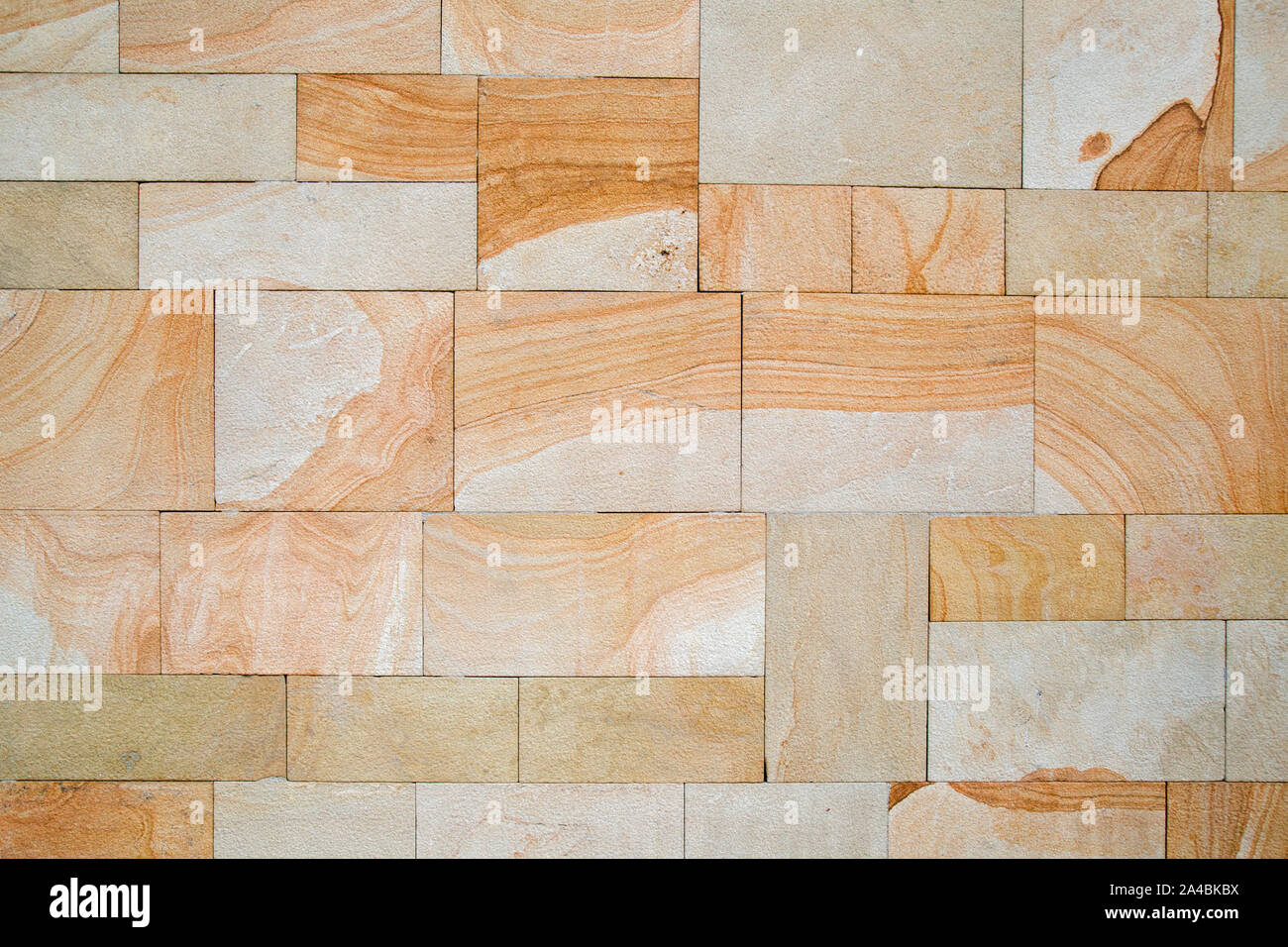 Golden coloured sandstone blocks in a wall, shot landscape format for ...