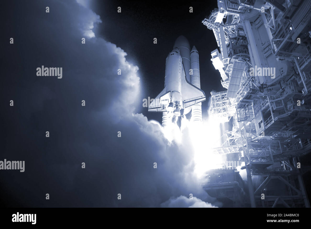 The launch of a space rocket at night, in clouds of smoke. Elements of ...