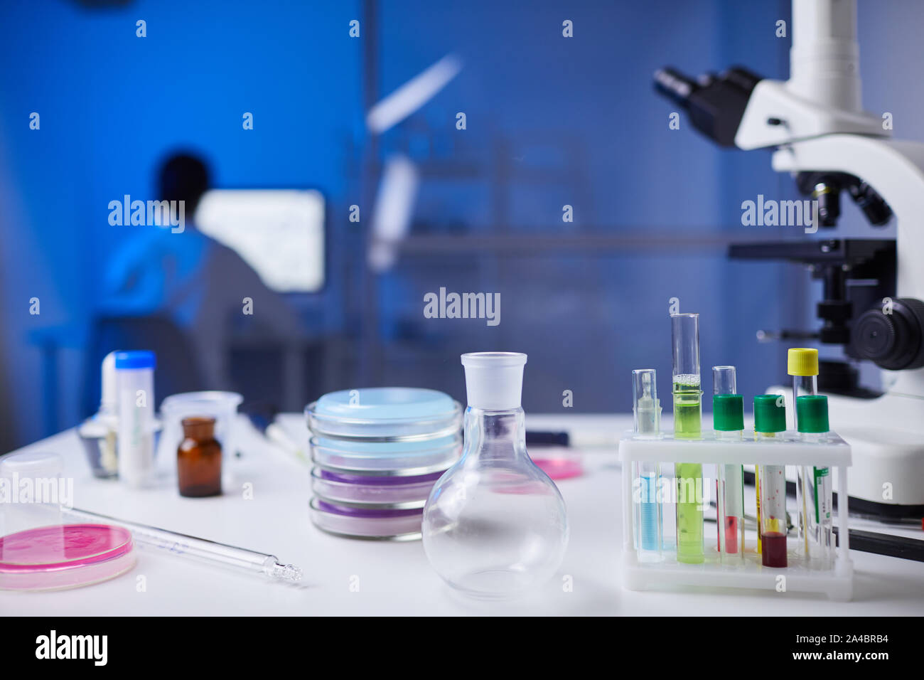 Background image of assorted laboratory equipment on workstation with ...