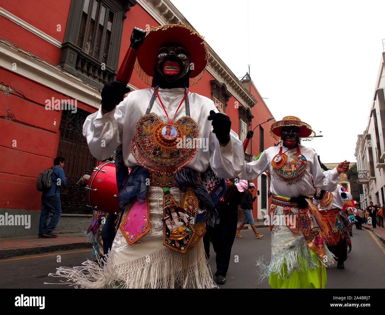 A dancer wearing typical costume and mask participating in the andean ...