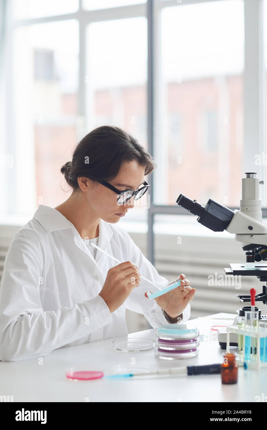 Side view portrait of beautiful young woman working in laboratory ...