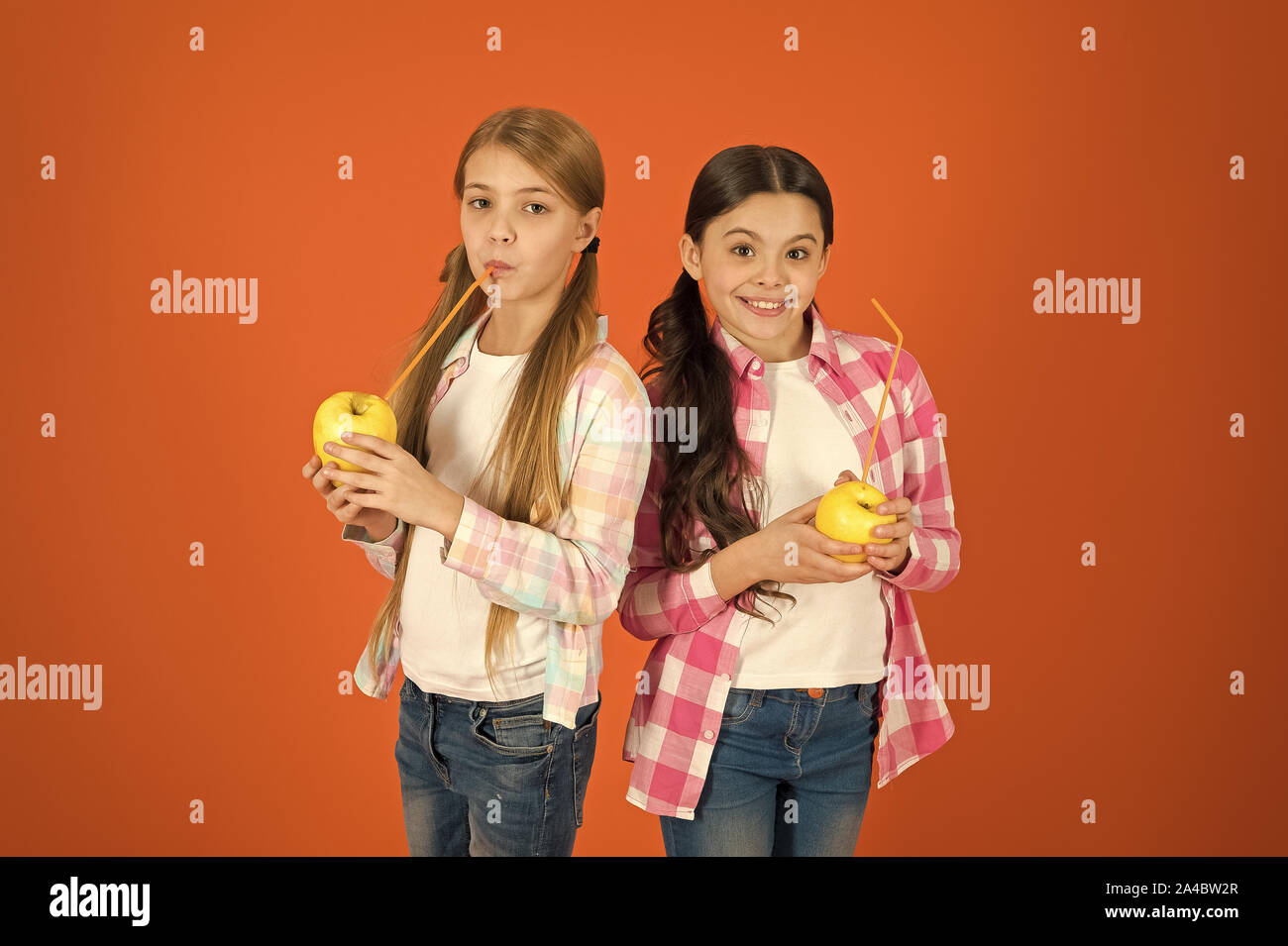 Schoolgirls eat apple fruit. School lunch. Vitamin fruit nutrition for ...