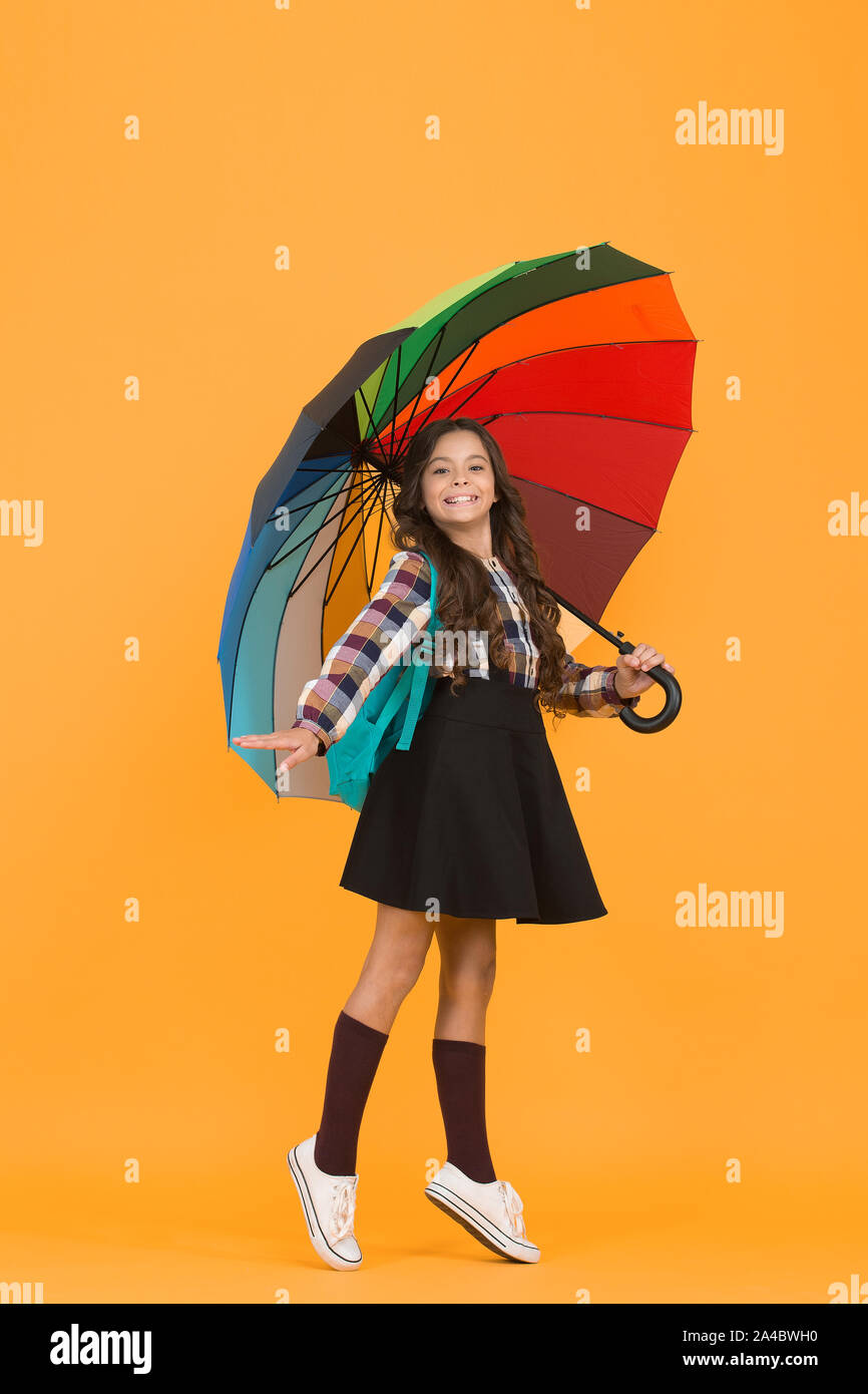 Rainy september. Towards knowledge. Schoolgirl with backpack. Schoolgirl daily life. Girl with ...