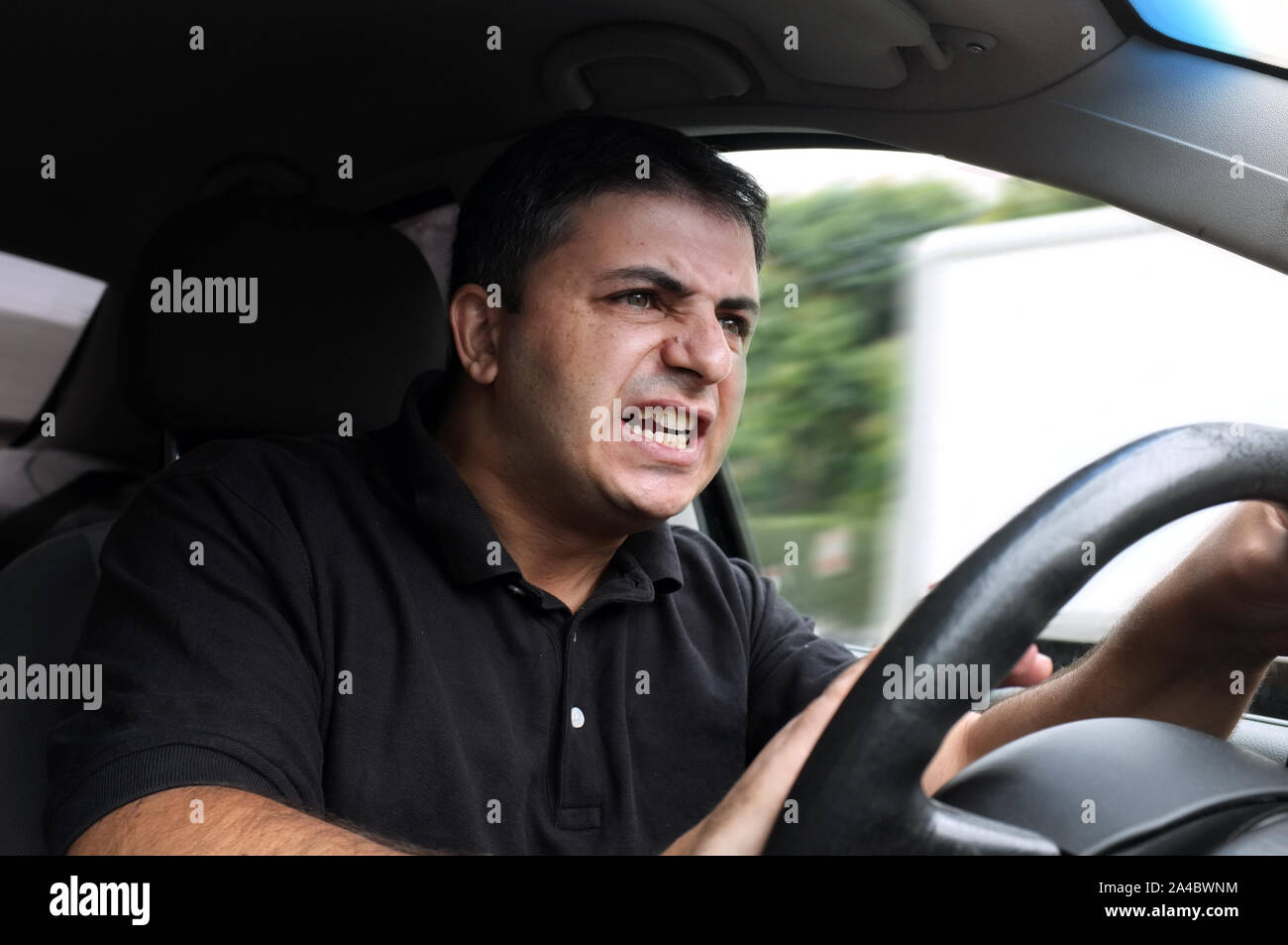 Angry man driving a vehicle Stock Photo - Alamy