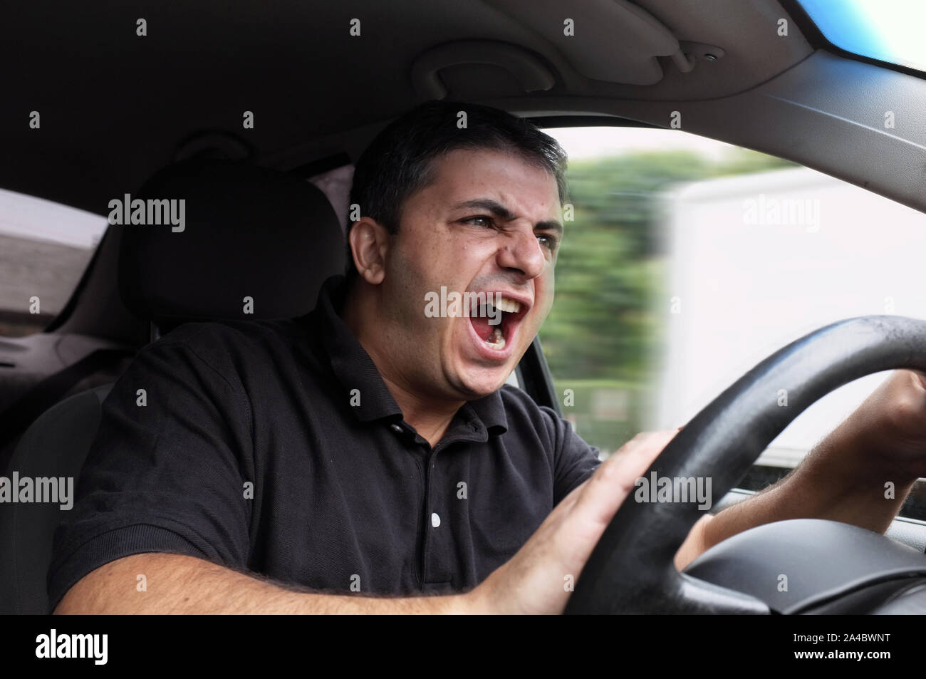 Angry man driving a vehicle Stock Photo - Alamy