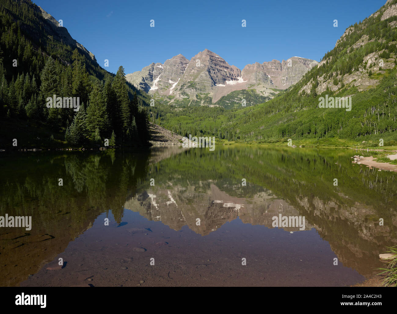The Maroon Bells twin-peak formation reflects in Maroon Lake, just ...