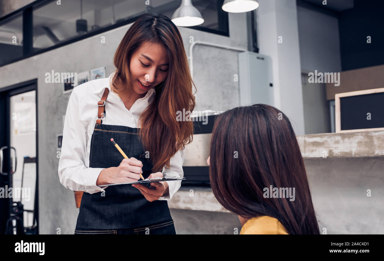 Young asian barista take order from customer in coffee shop,cafe owner ...