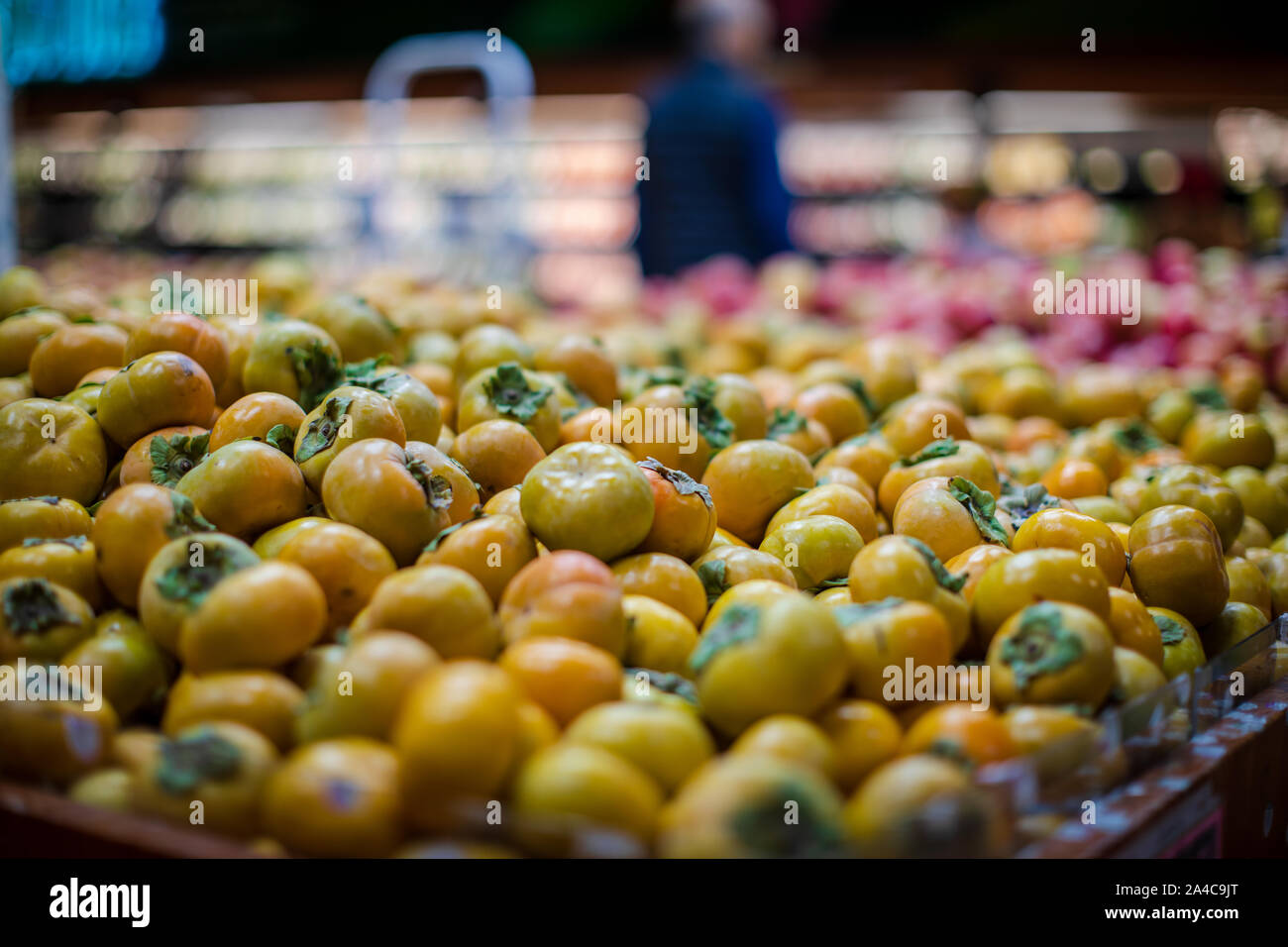 Fresh autumn persimmon in a market. Selective focus Stock Photo - Alamy