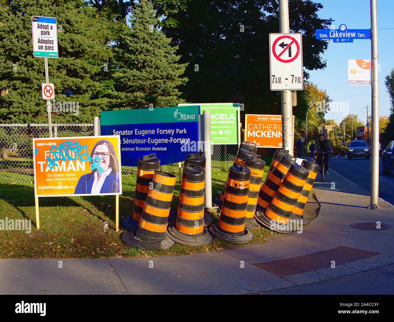 Orange bollards, a bus stop, cyclists and Federal election campaign ...