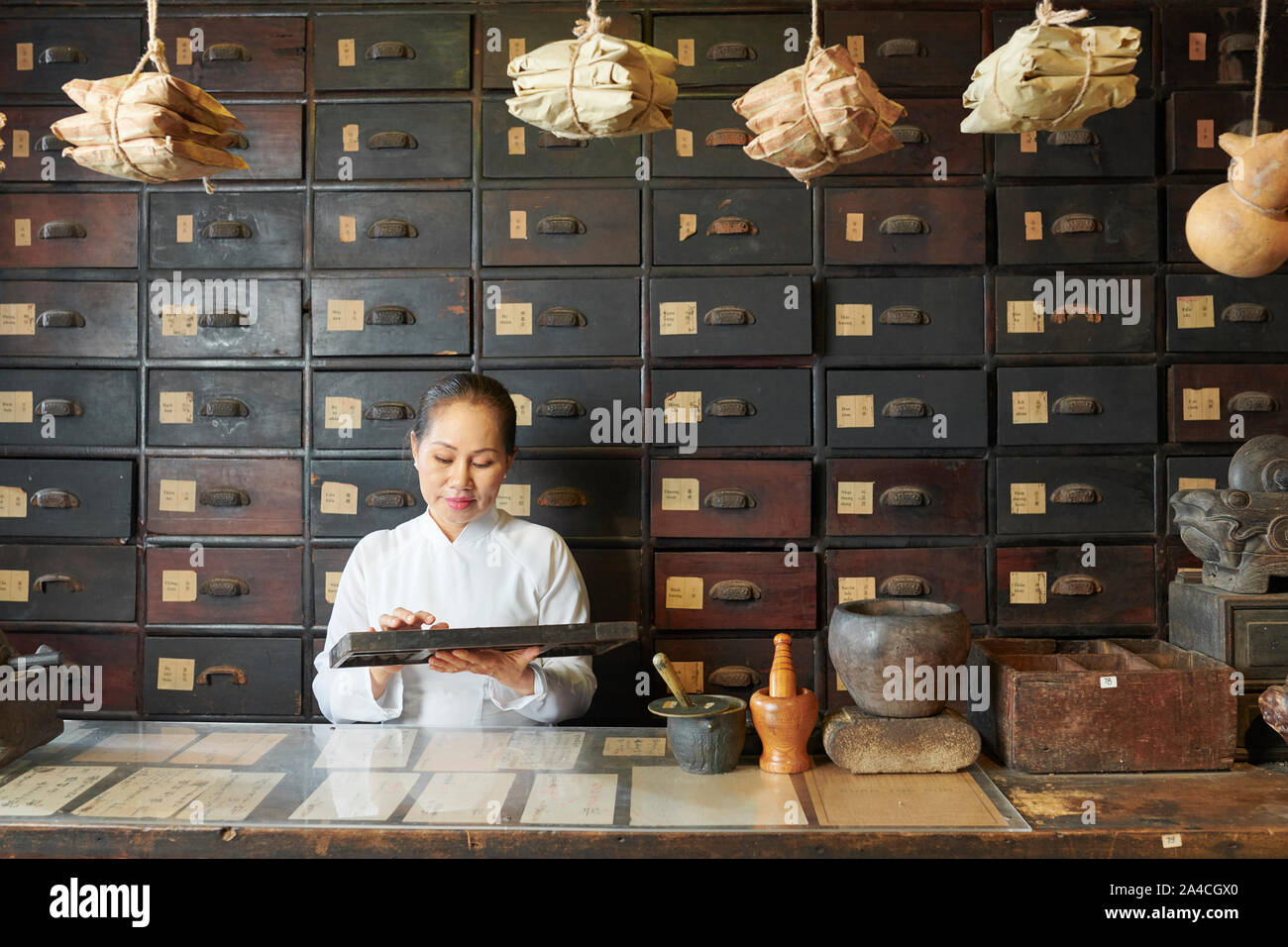Traditional Chinese medicine practitioner using abacus for counting ...