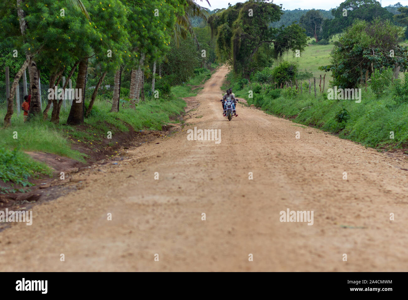 A motorcycle rider carrying passengers Stock Photo - Alamy