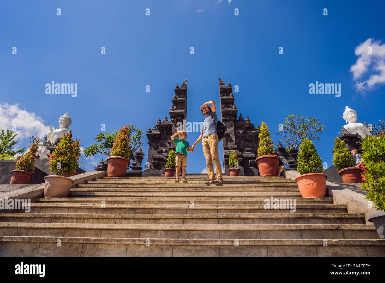 Dad and son tourists in budhist temple Brahma Vihara Arama Banjar Bali ...