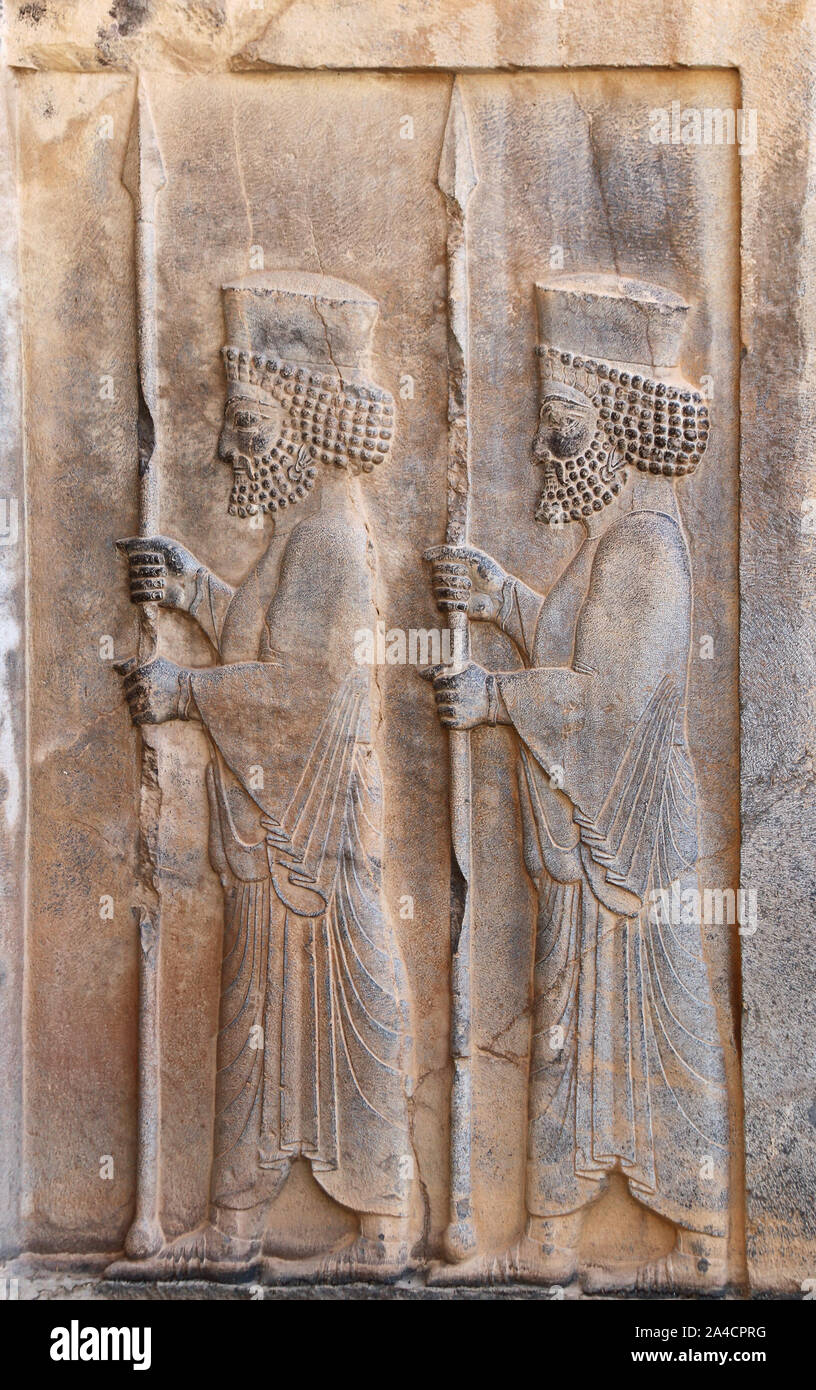 Bas-relief with assyrian warriors with spears on wall of tomb of ...