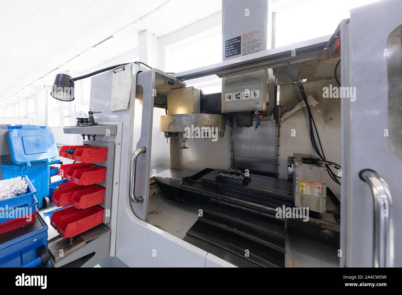 New computerized factory equipment processing metal parts inside ...