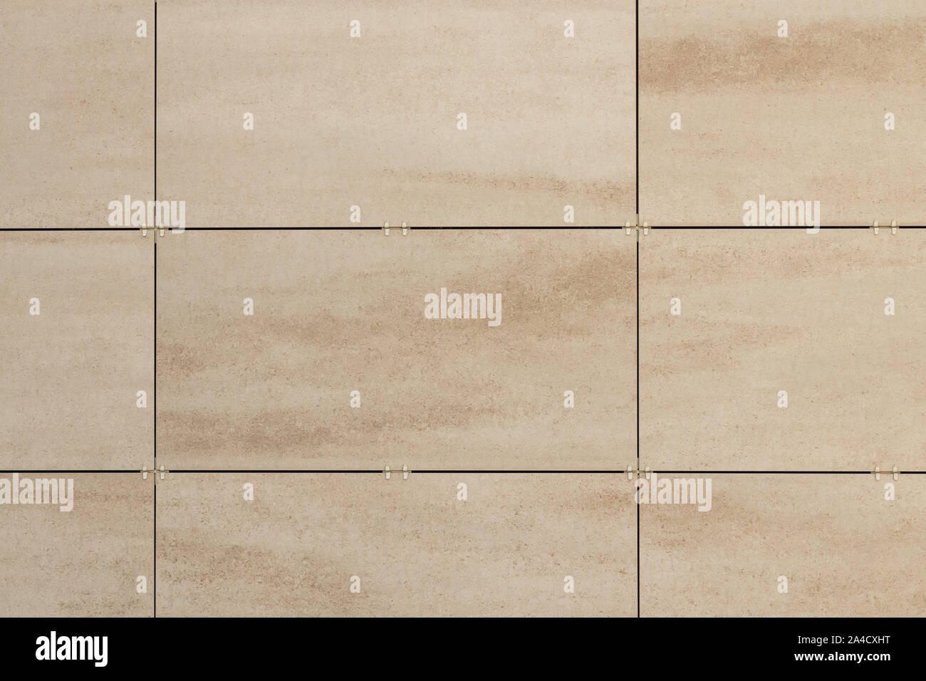 Textured pattern on beige rectangular tiles with dark space in between ...