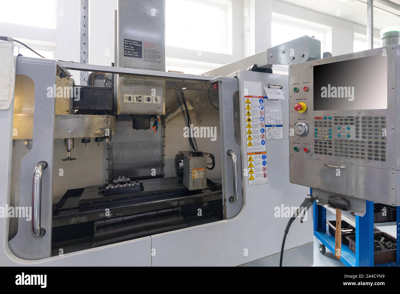 Modern computerized factory equipment processing metal parts with ...