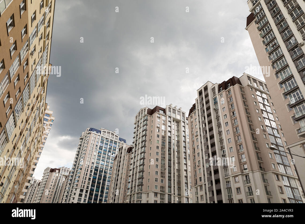 Cloudy weather, autumn sky with dark clouds. Many apartment buildings ...