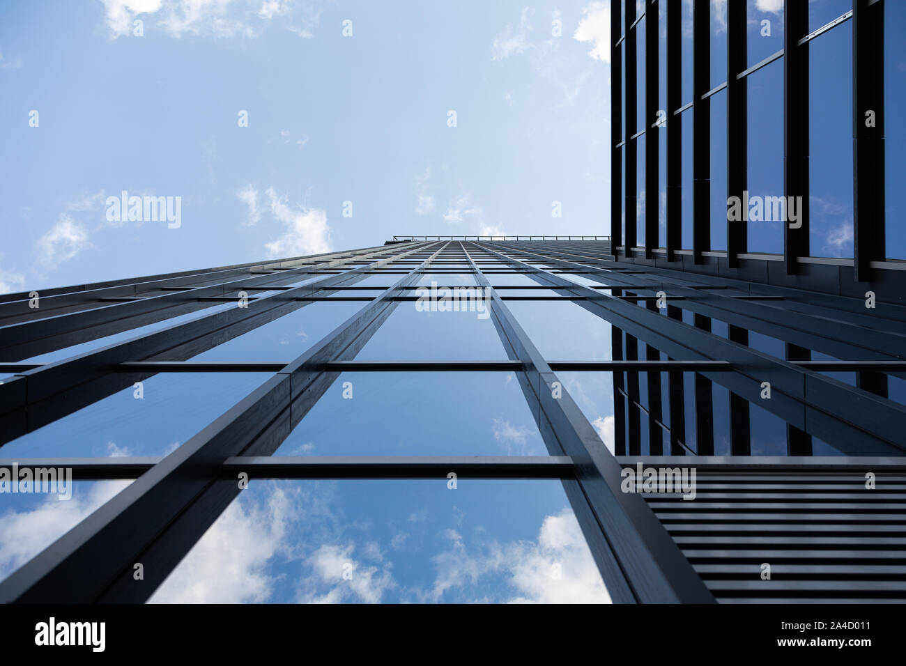 Ground view of tall glass building wall Stock Photo - Alamy