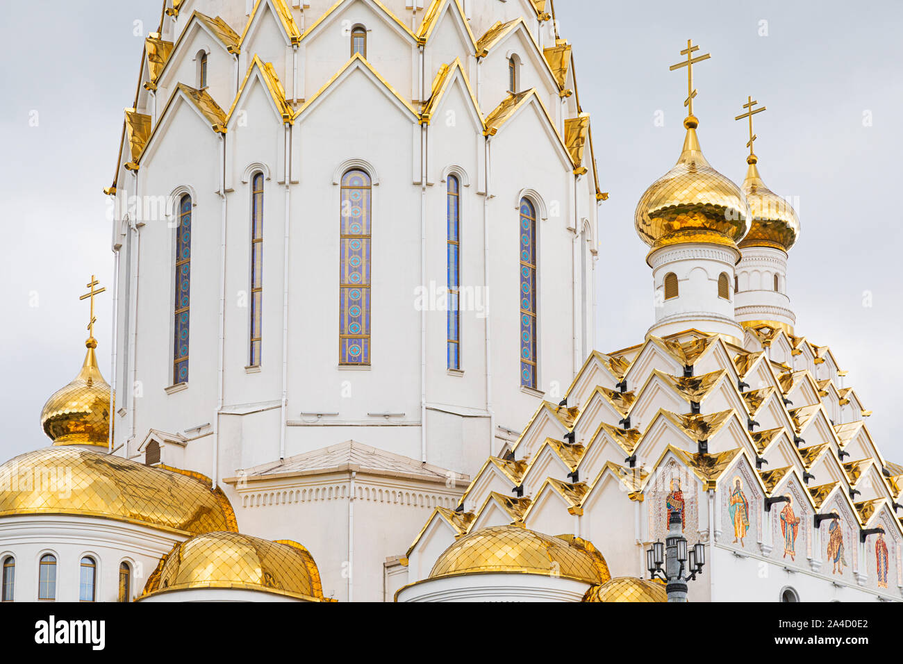Close-up of gilded domes of christian church with stained glass windows ...