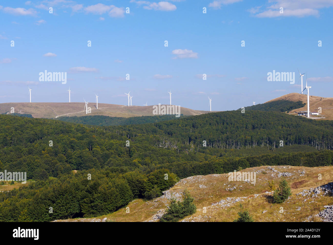 Wind generators in the mountains. Blue sky and white clouds for ...