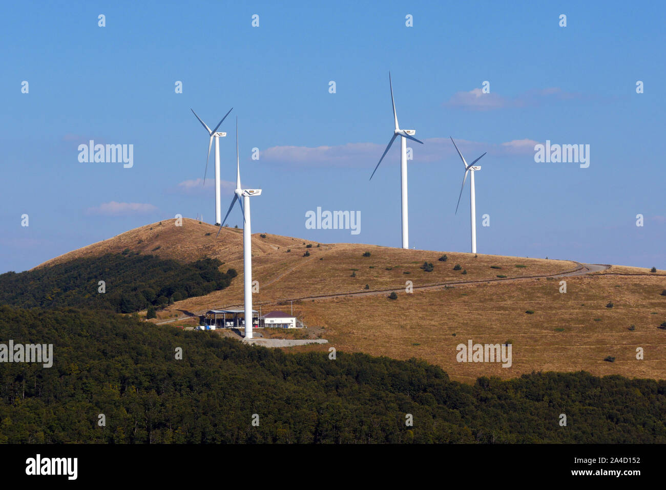 Wind generators in the mountains. Blue sky and white clouds for ...