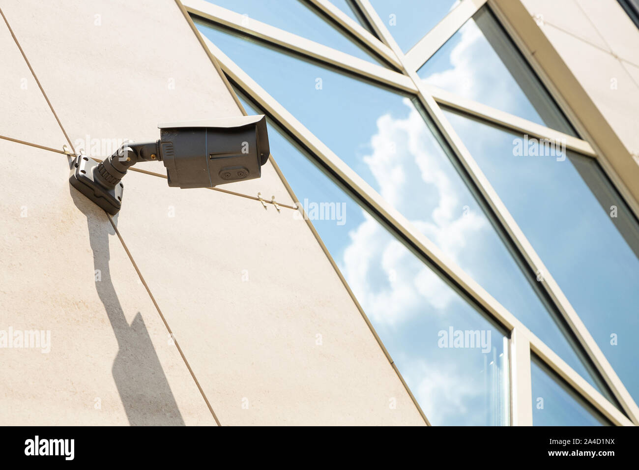 Ground diagonal view of safety camera on beige tiled wall surface with ...