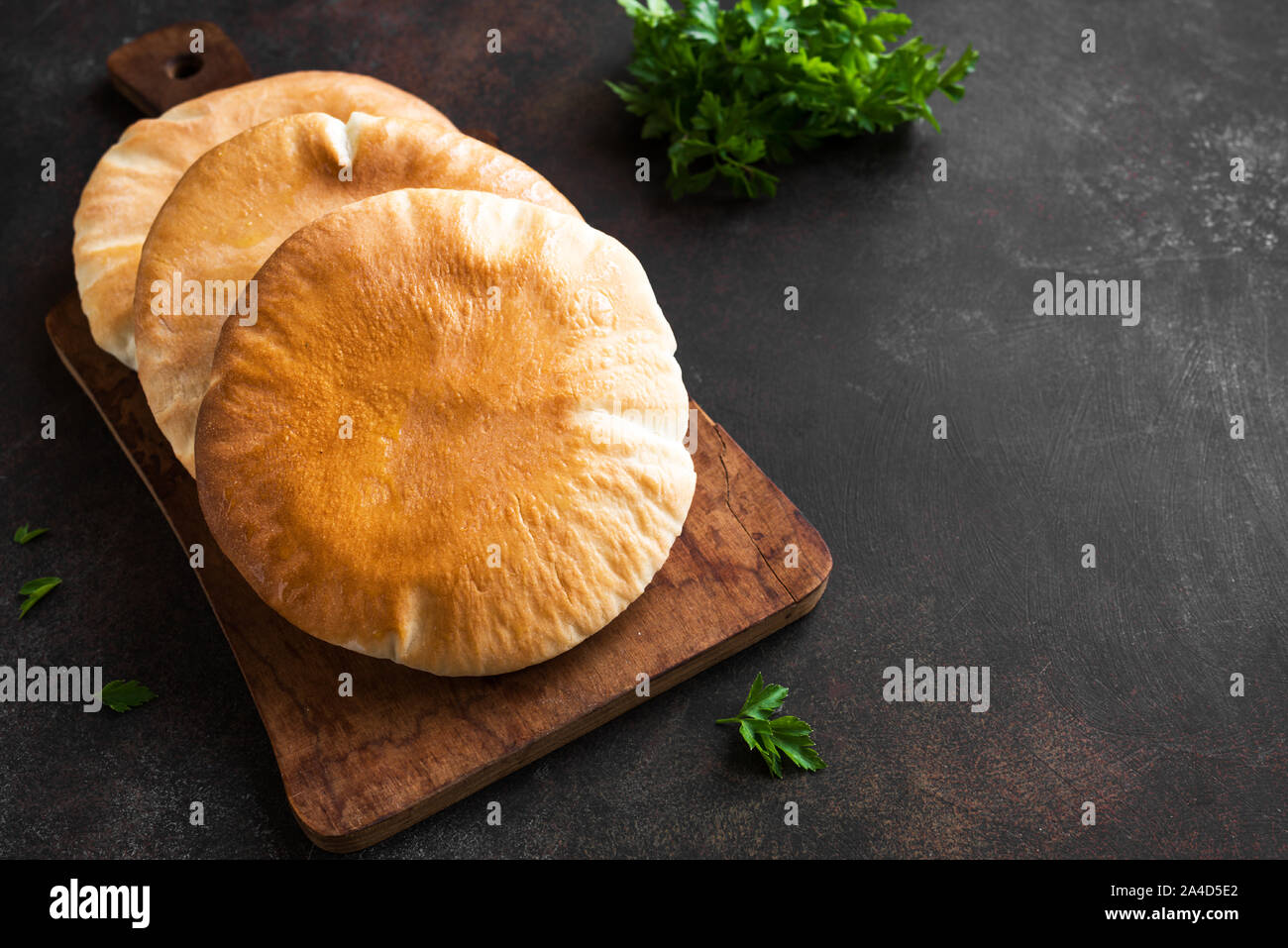 Arabic Pita Flat Bread on dark rustic background, top view, copy space ...
