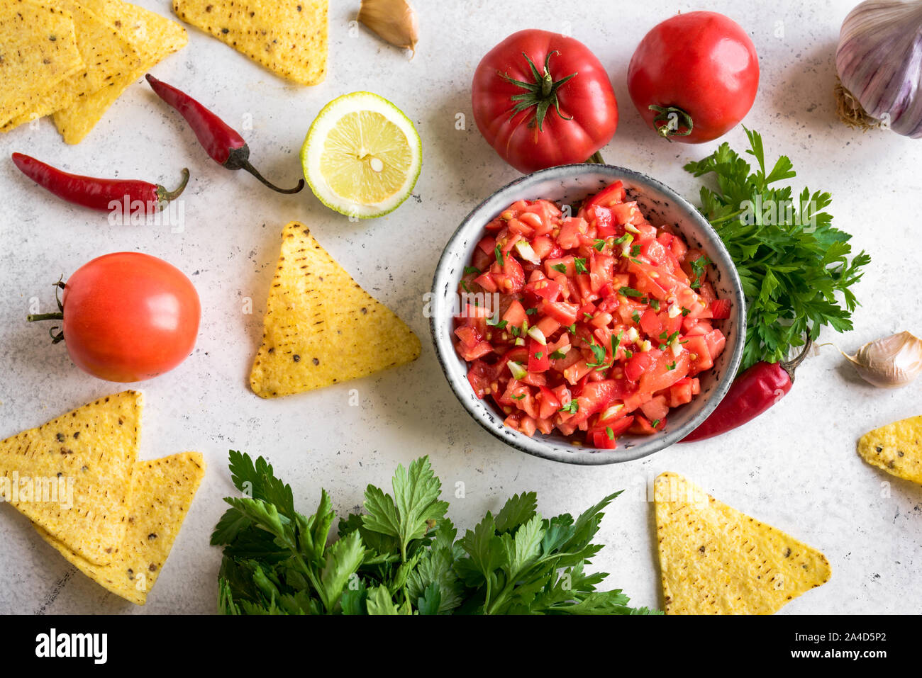Hot mexican salsa sauce and ingredients on white background, top view ...
