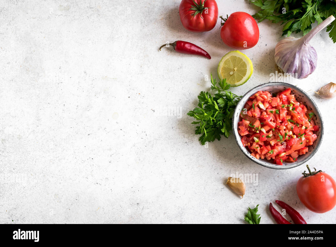 Hot mexican salsa sauce and ingredients on white background, top view ...