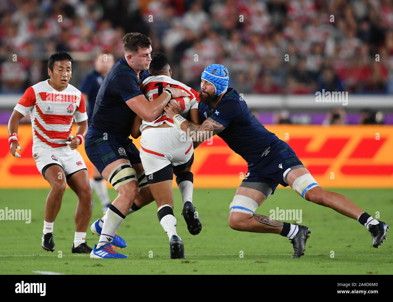 Japan's William Tupou is tackled by Scotland's Magnus Bradbury and ...