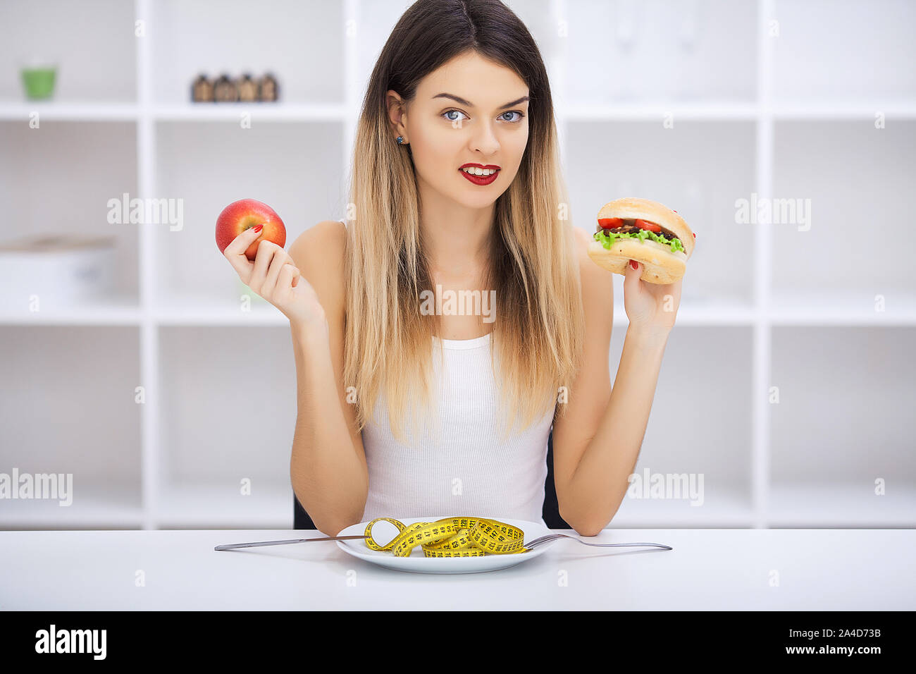 Choose between junk food versus healthy diet Stock Photo - Alamy